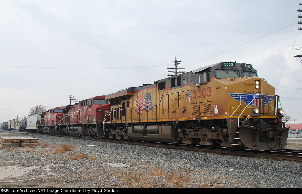 UP 5303 with two Canadian Pacific Units head west